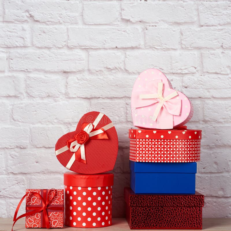 Stack of Various Boxes with Gifts on White Brick Background Stock Image ...