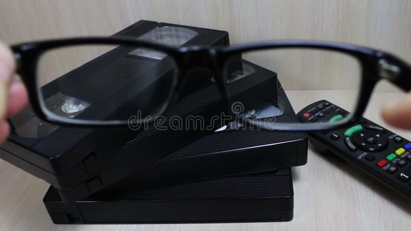 Stack of VHS Video Tape Cassette and Glass Stock Footage - Video of ...
