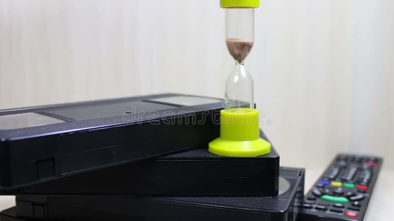 Stack of VHS Video Tape Cassette and Hourglass Stock Footage - Video of ...