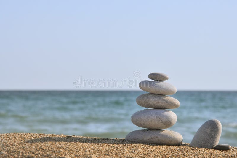 Stack of Volcanic Pebbles in Calm Water Stock Image - Image of water ...