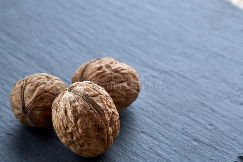A Stack of Walnuts Piled Together and on Dark Background, Shallow Depth ...