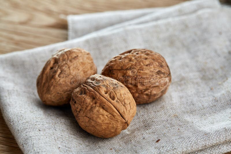 A Stack of Walnuts Piled Together and on Rustic Wooden Background ...