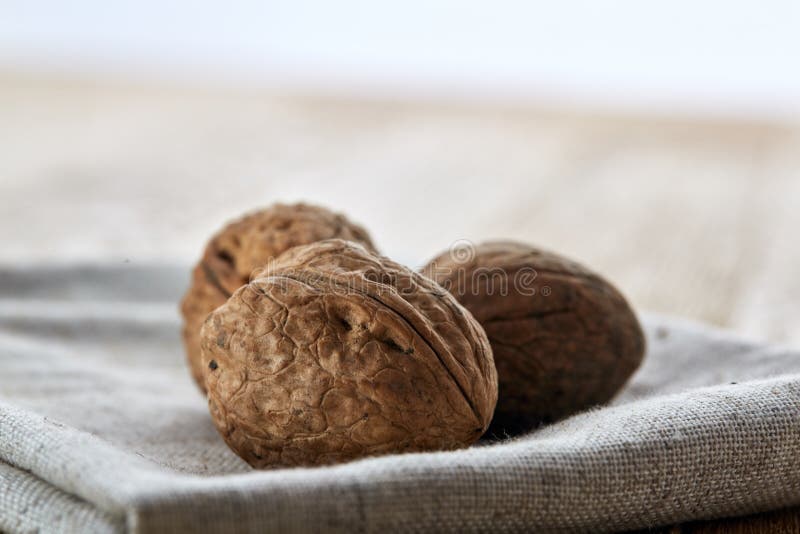 A Stack of Walnuts Piled Together and on Rustic Wooden Background ...