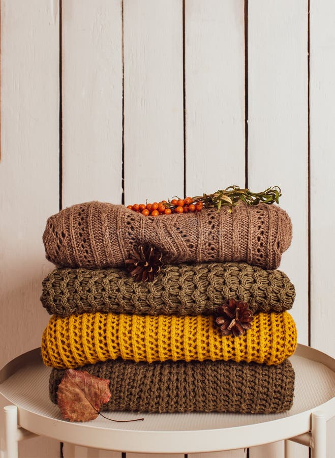A Stack of Warm Knitted Vintage Sweaters on a White Wooden Background ...