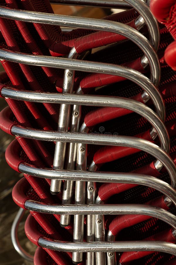 Stack of wet red chairs stock image. Image of metal - 167635173