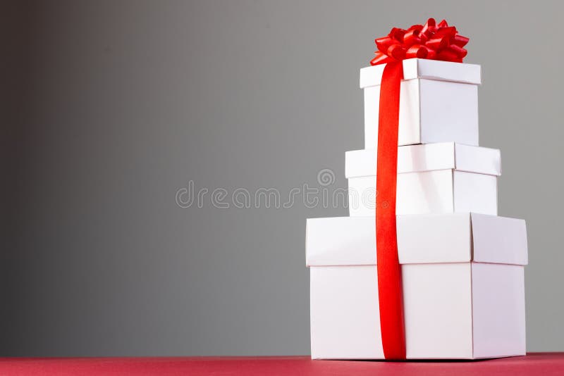 Stack of White Christmas Presents with Red Ribbon and Copy Space on ...