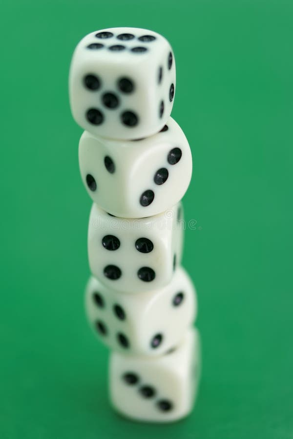 Stack of White Dice Balancing on a Green Background during a Gam Stock ...