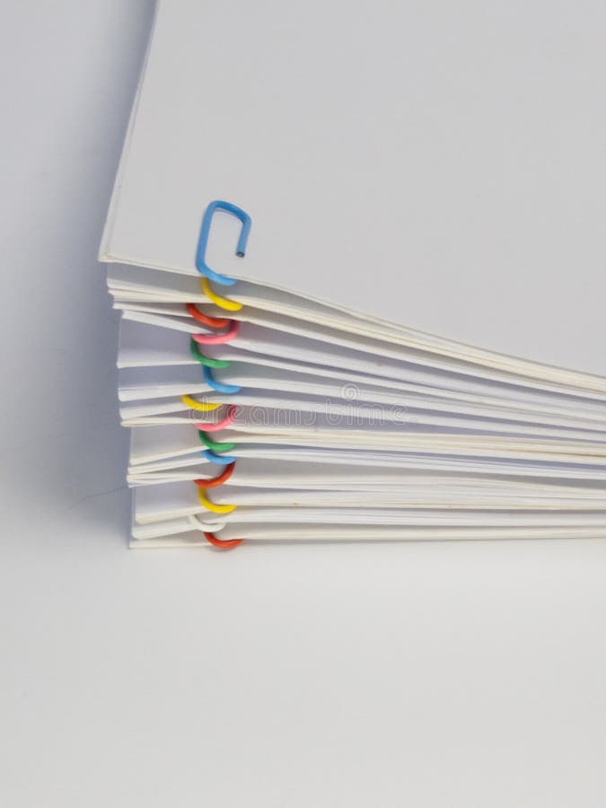 Stack of White Paper with Colorful Paperclips on a White Surface Stock ...