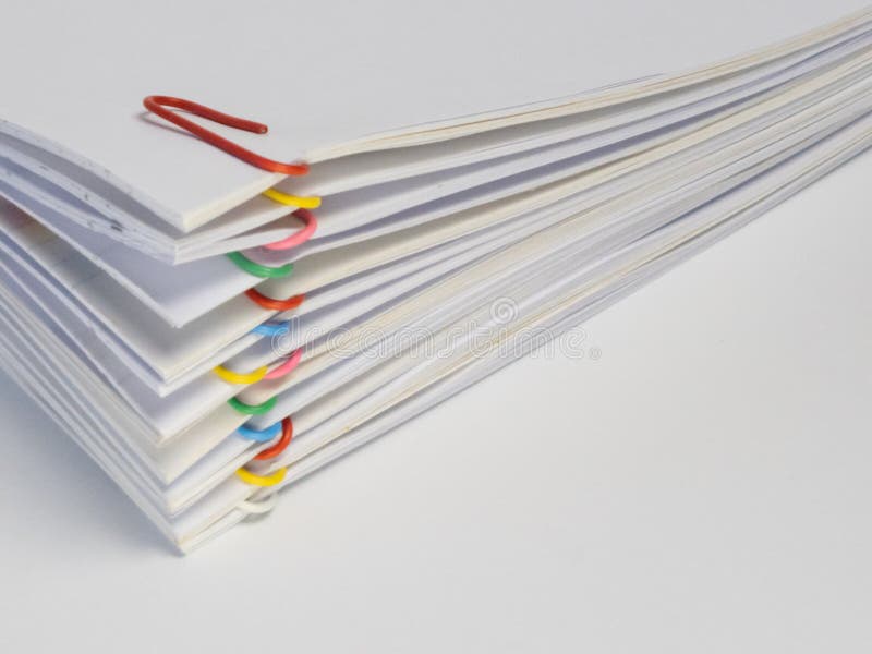Stack of White Paper Documents Held Together with Colorful Paperclips ...