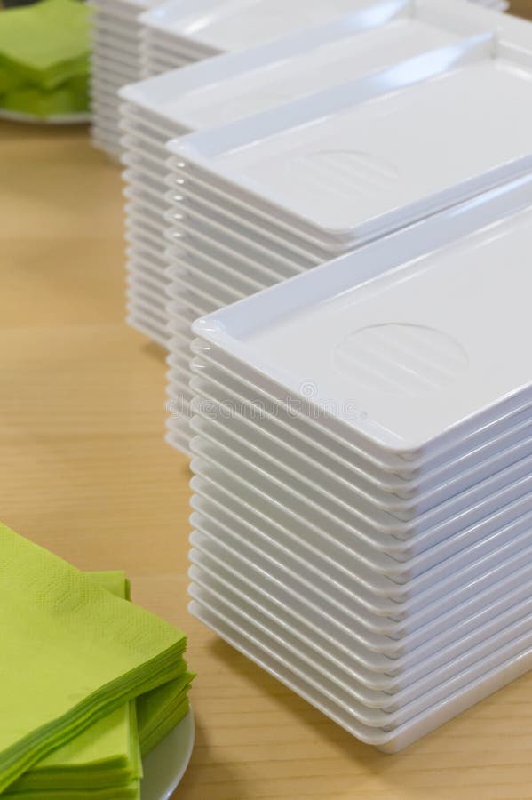 A Stack of Plastic Plates and Napkins on a Table Stock Photo - Image of ...