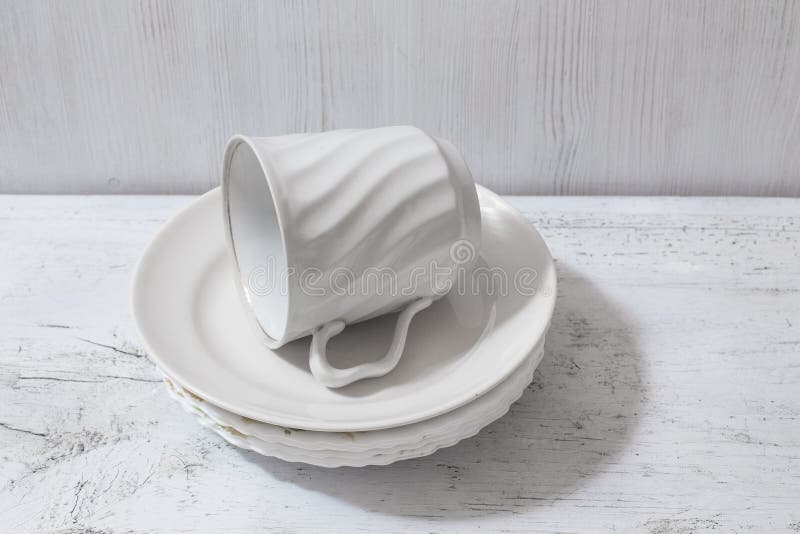 Stack of White Plates and Cup on Table Stock Photo - Image of dinner ...