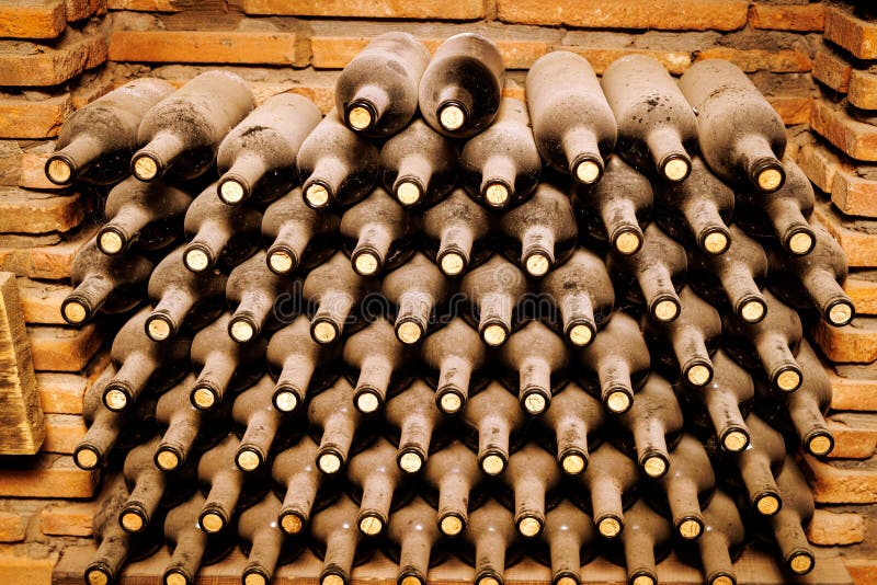 A Stack of Wine Bottles with a Brick Wall Behind Them Stock Photo ...
