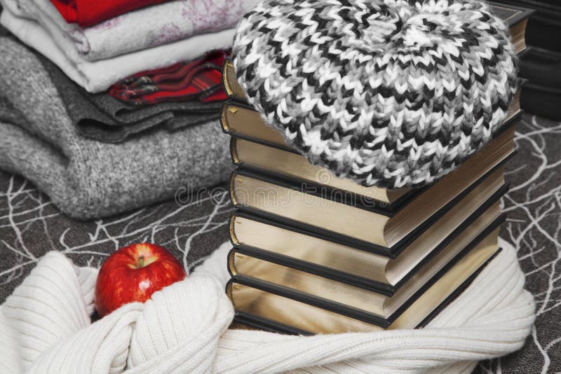 Stack of Winter Clothes and Books with Glossy Edge Stock Image - Image ...