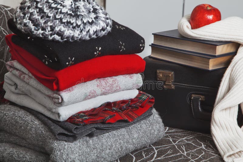Stack of Winter Clothes and Books with Glossy Edge Stock Image - Image ...
