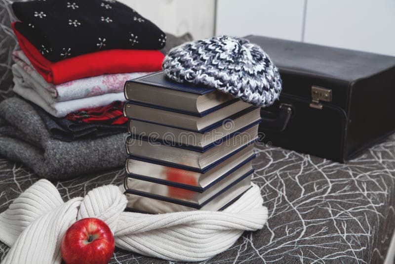 Stack of Winter Clothes and Books with Glossy Edge Stock Image - Image ...