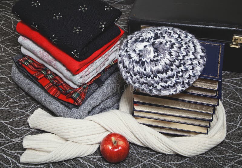 Stack of Winter Clothes and Books with Gold Edge Stock Photo - Image of ...