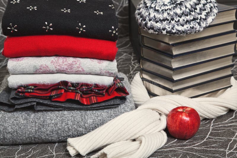 Stack of Winter Clothes and Books with Glossy Edge Stock Image - Image ...