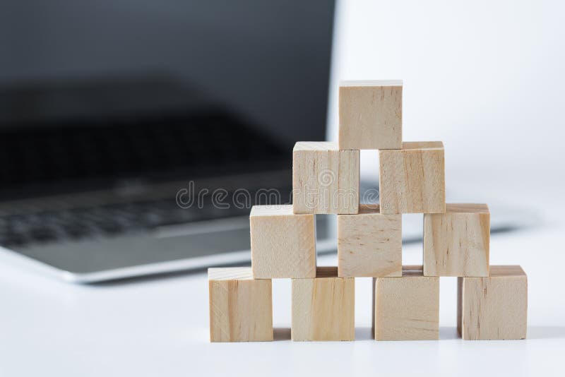 Stack of Wood Cube Building Blocks with Laptop Computer Backgro Stock ...