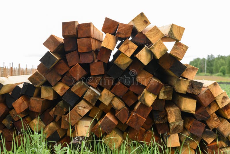 Stack of Wooden Bars in Warehouse. Stacked Wooden Beams of Square ...