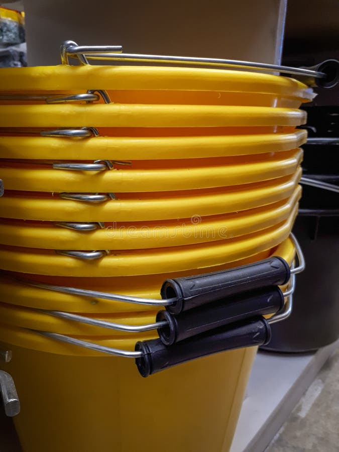 A Stack of Yellow Buckets with Black Handles Stock Image - Image of ...