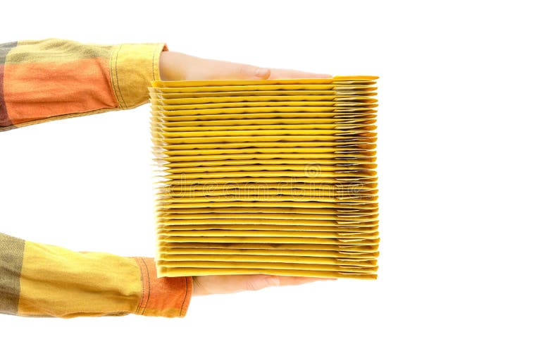 Stack of Yellow Padded Envelopes in Hands on White Stock Image - Image ...