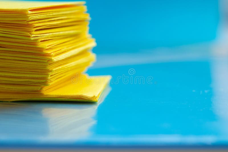 Stack of Yellow Paper on Blue Table Stock Image - Image of corporate ...