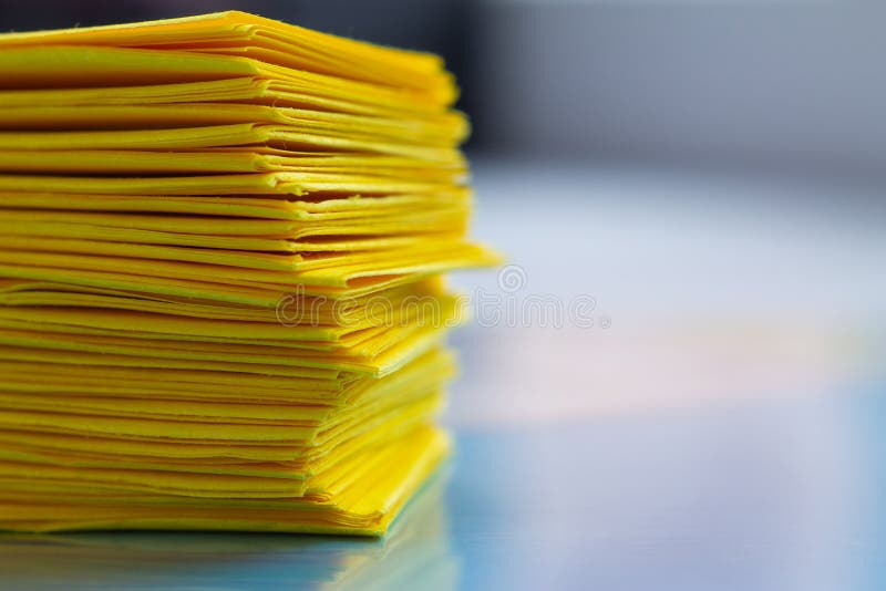 Stack of Yellow Paper on Blue Table Stock Photo - Image of evening ...