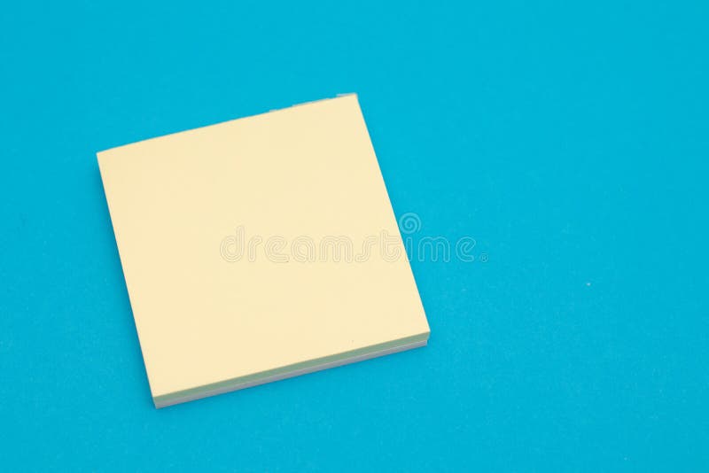 Stack of Yellow Paper Stickers on Blue Background Stock Photo - Image ...