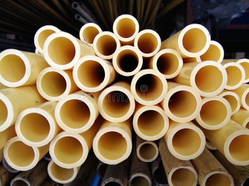 Stack of yellow pvc pipes stock photo. Image of pattern - 123187136