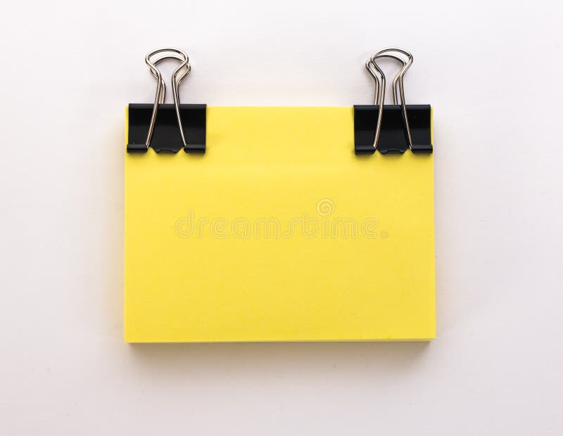 Stack of Yellow Sheets of Paper with Black Paper Clip on a White Stock ...