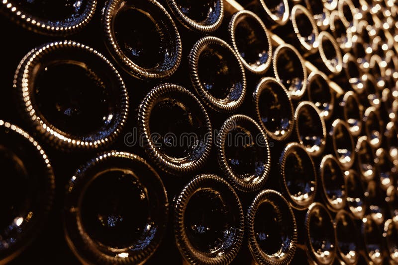 Stacked Aging Wine Bottles in Modern Cellar Stock Image - Image of ...