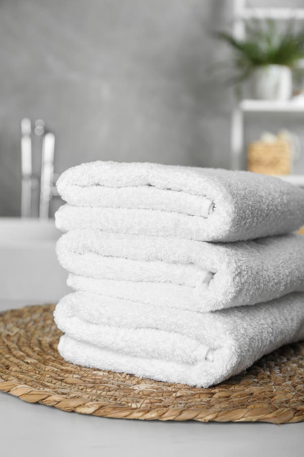 Stacked Bath Towels on Light Table in Bathroom Stock Image - Image of ...