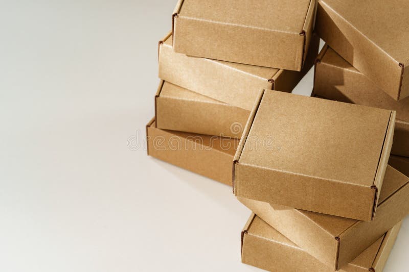 Stacked Brown Cardboard Boxes on White Surface Close Up Stock Photo ...