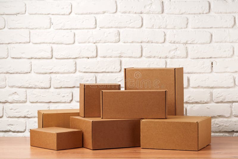 Stacked Cardboard Boxes Against a White Brick Wall Close Up Stock Image ...