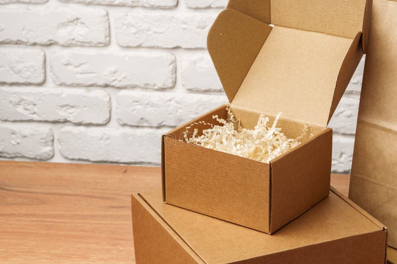 Stacked Cardboard Boxes Against a White Brick Wall Close Up Stock Photo ...