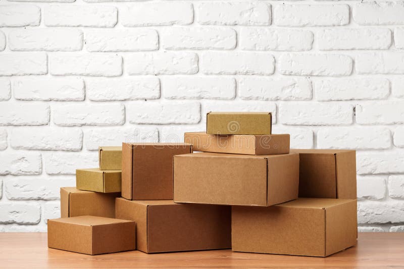Stacked Cardboard Boxes Against a White Brick Wall Close Up Stock Image ...