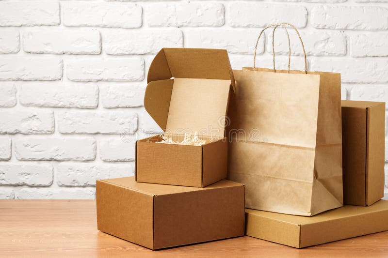 Stacked Cardboard Boxes Against a White Brick Wall Close Up Stock Image ...