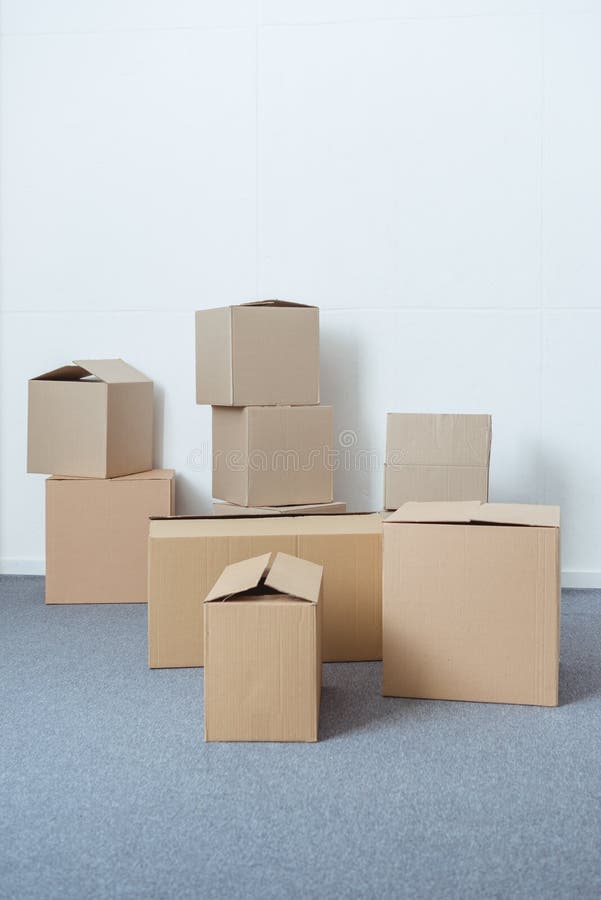 Stacked Cardboard Boxes in Empty Room Stock Image - Image of packages ...