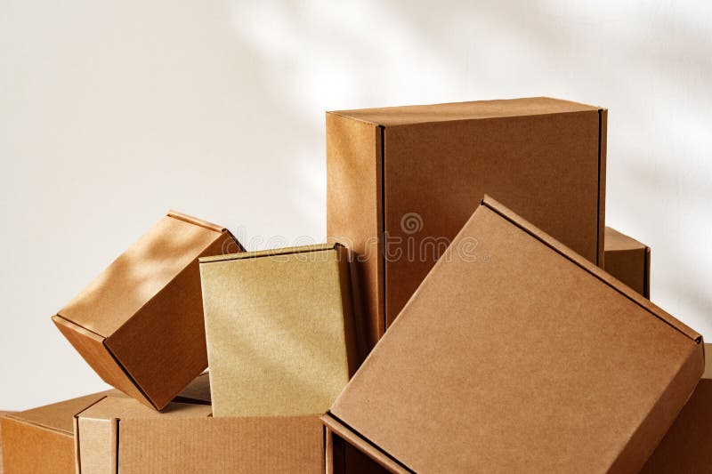 Stacked Cardboard Boxes on Wooden Surface in Sunlight Stock Photo ...