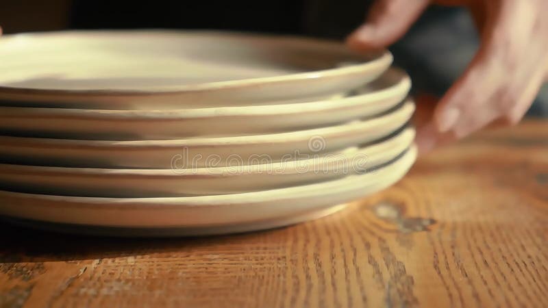 Stacked Ceramic Plates on a Rustic Wood Table Stock Footage - Video of ...