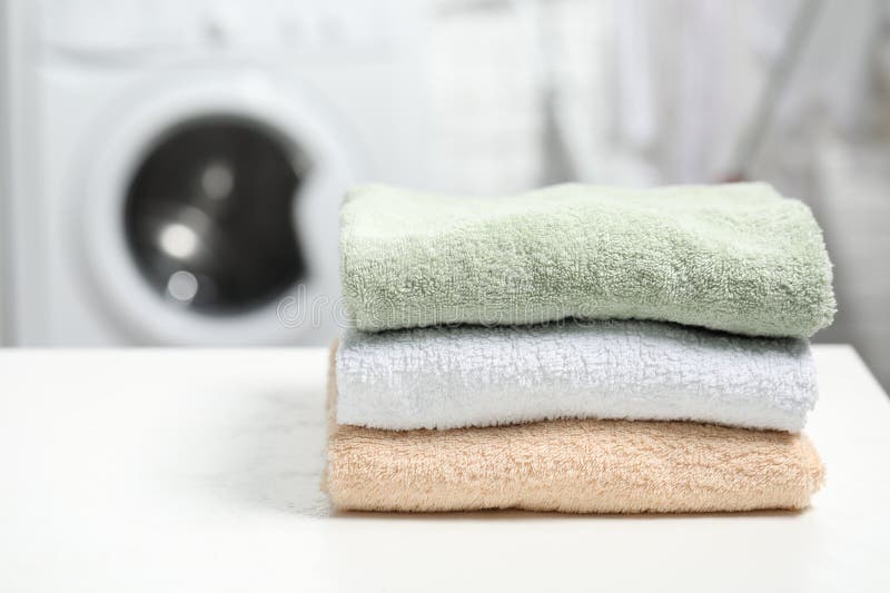 Stacked Clean Towels on White Table in Bathroom, Space for Text Stock ...