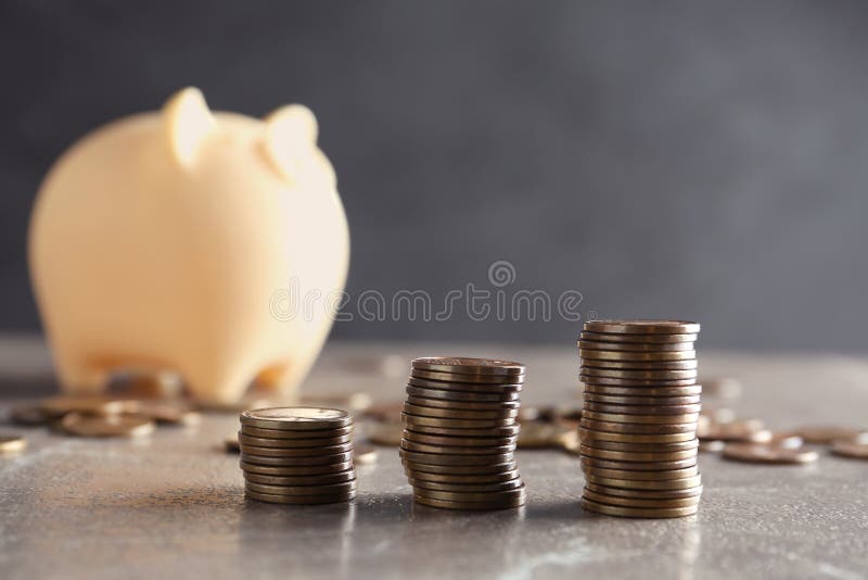 Stacked Coins and Bank on Brown Marble Table Stock Photo - Image of ...