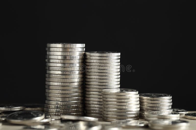 Stacked Coins on Table Against Black Background, Closeup. Salary ...