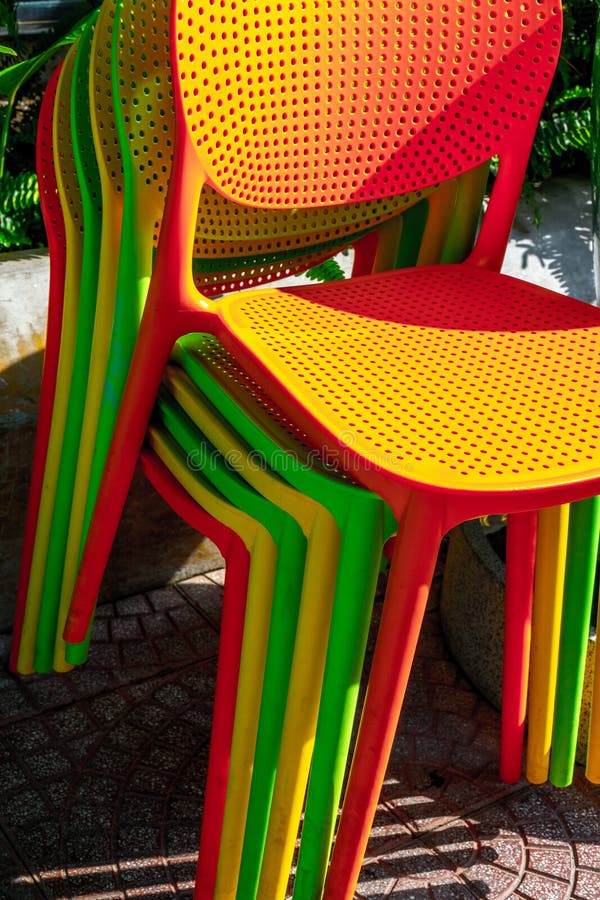 Stacked Colorful Chairs in Outdoor Setting Stock Photo - Image of ...