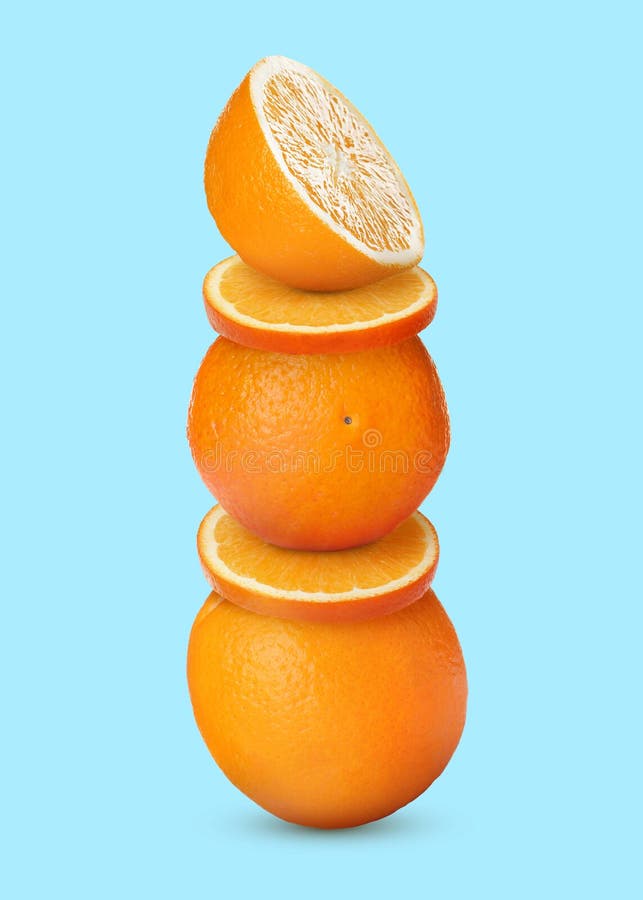 Stacked Cut and Whole Oranges on Pale Light Blue Background Stock Image ...