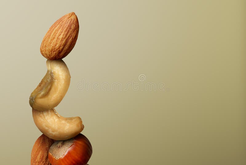 Stacked Different Nuts on Light Brown Gradient Background, Space for ...