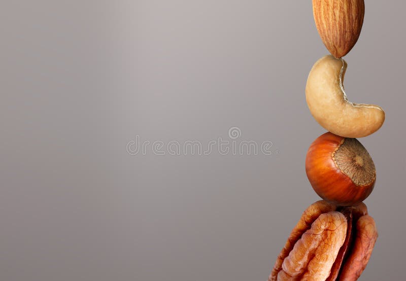 Stacked Different Nuts on Light Grey Gradient Background, Space for ...
