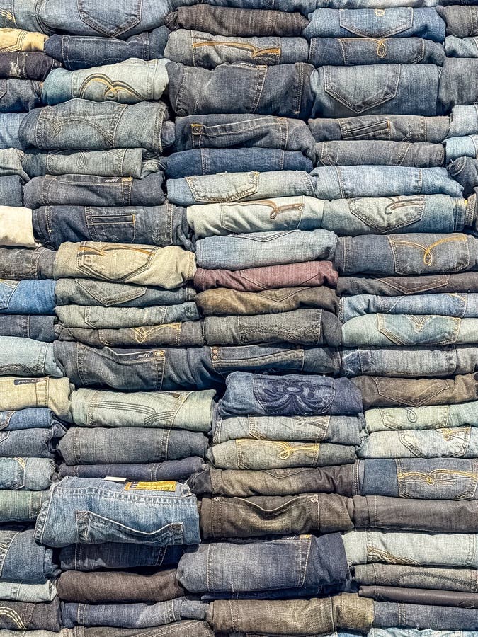 Stacked Folded Jeans in Various Shade of Blue, Creating a Textured ...