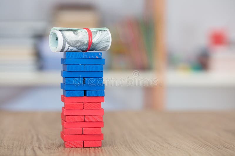 Stacked High Blocks on a Roll of Dollar Bills Stock Image - Image of ...