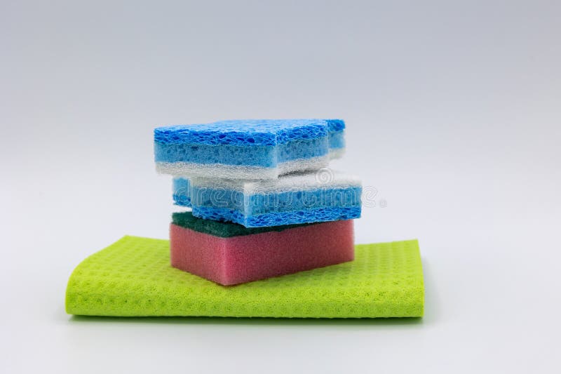 Stacked Kitchen Sponges of Different Colors on a Light Background ...